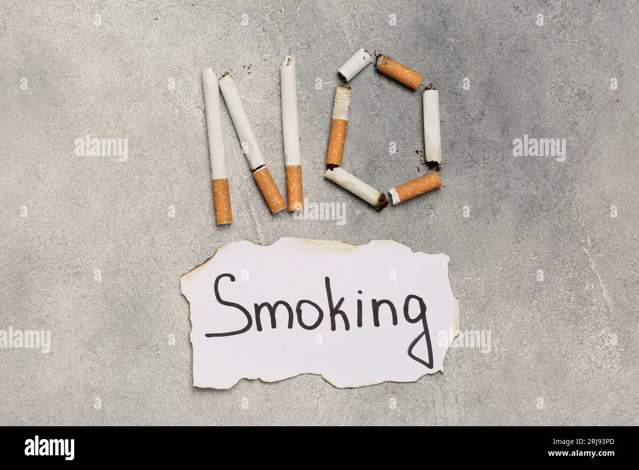 Words No Smoking made with cigarettes and paper on grey table, flat lay ...