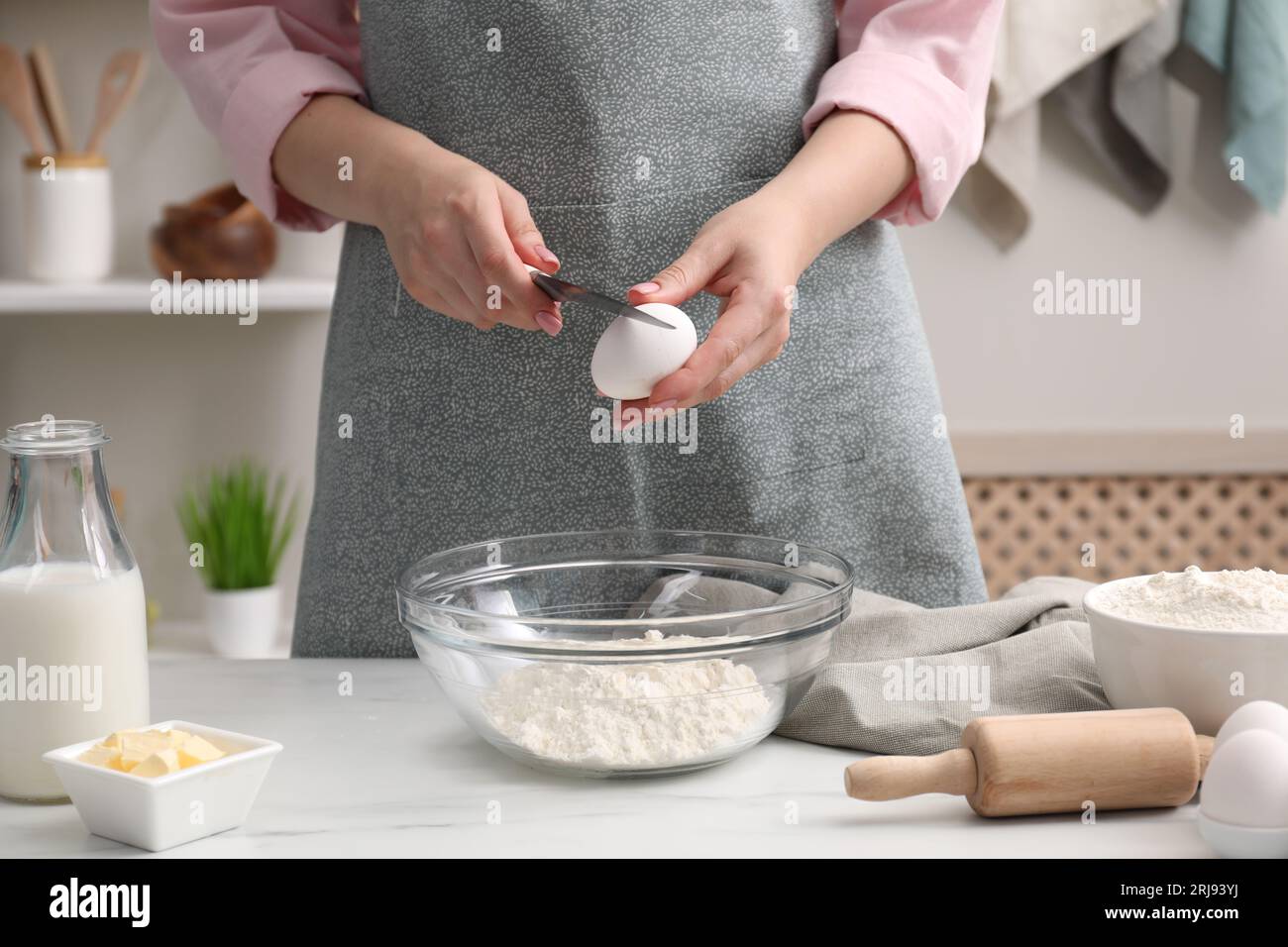 Preparing tasty baklava. Woman making dough at white table, closeup ...