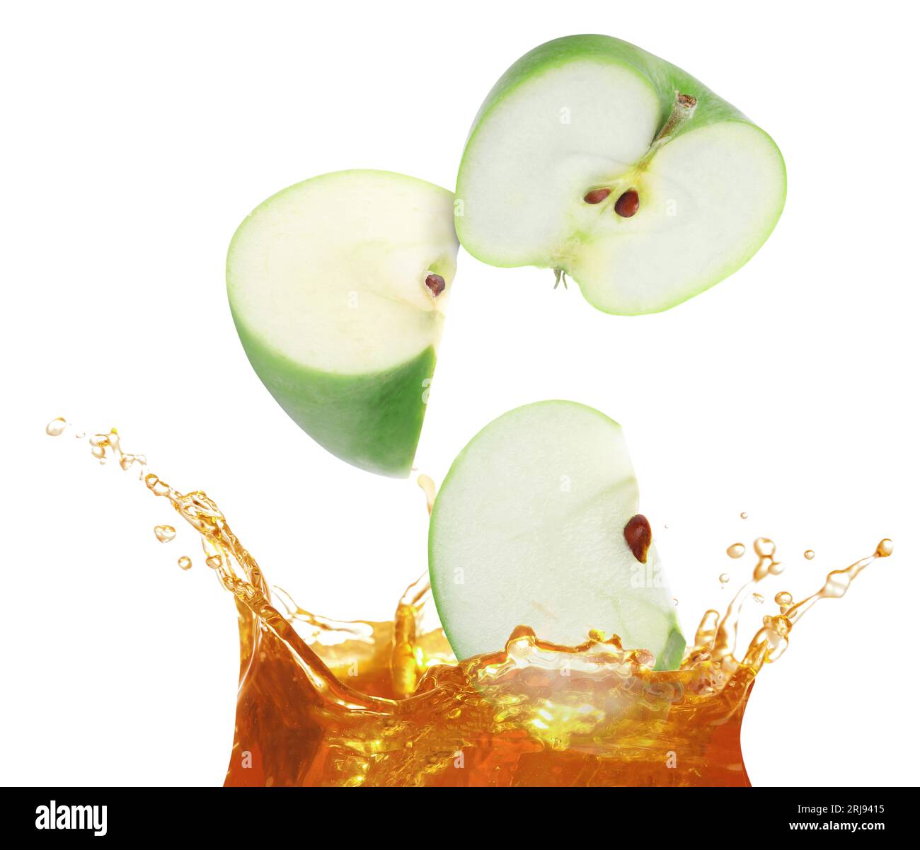 Cut apple falling into juice on white background Stock Photo - Alamy