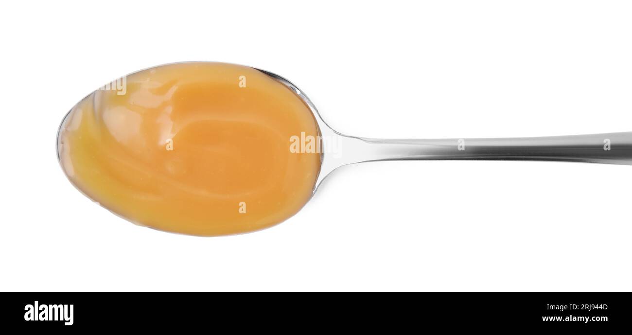 Spoon with tasty salted caramel isolated on white, top view Stock Photo ...
