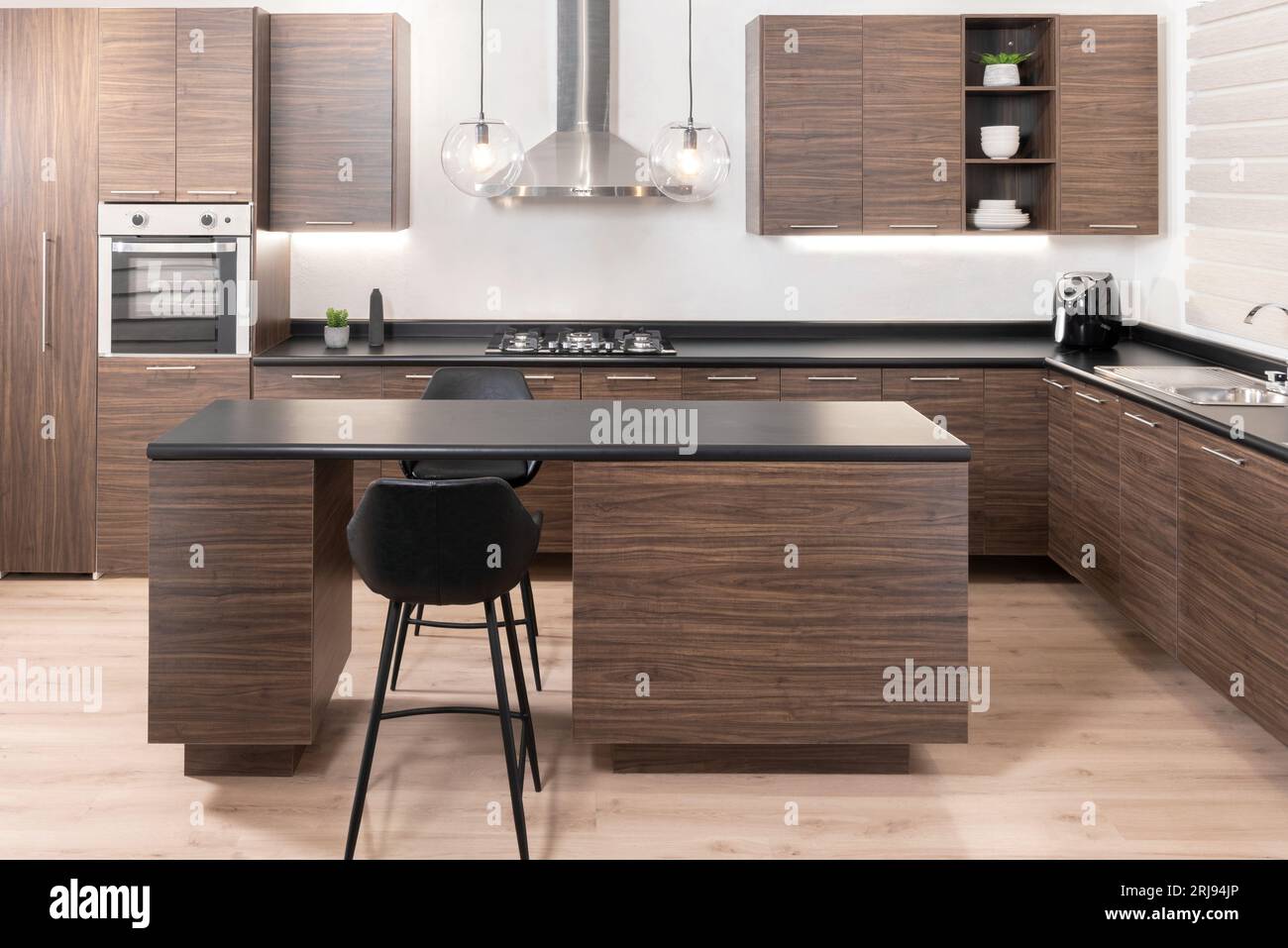 A modern kitchen with a clean, organized counter and a fully stocked ...