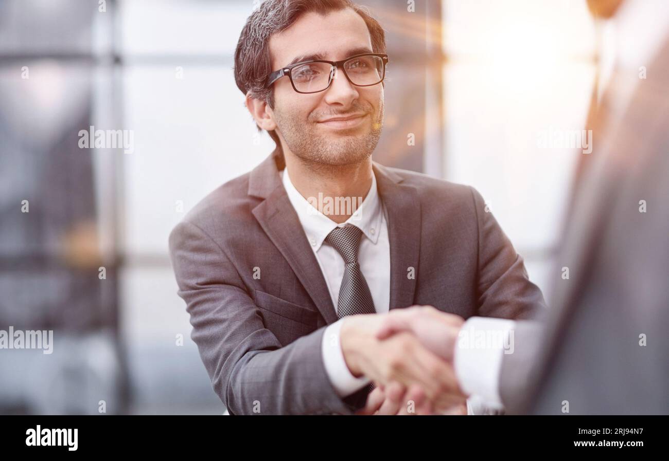 Portrait of cheerful young manager handshake with new employee Stock ...