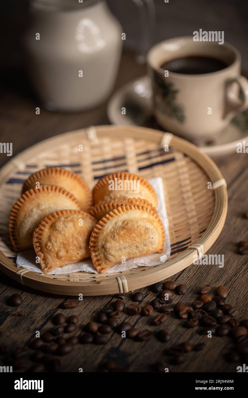 Fried Curry Puffs on a Rattan Plate with a Cup of Coffee. Malaysian ...