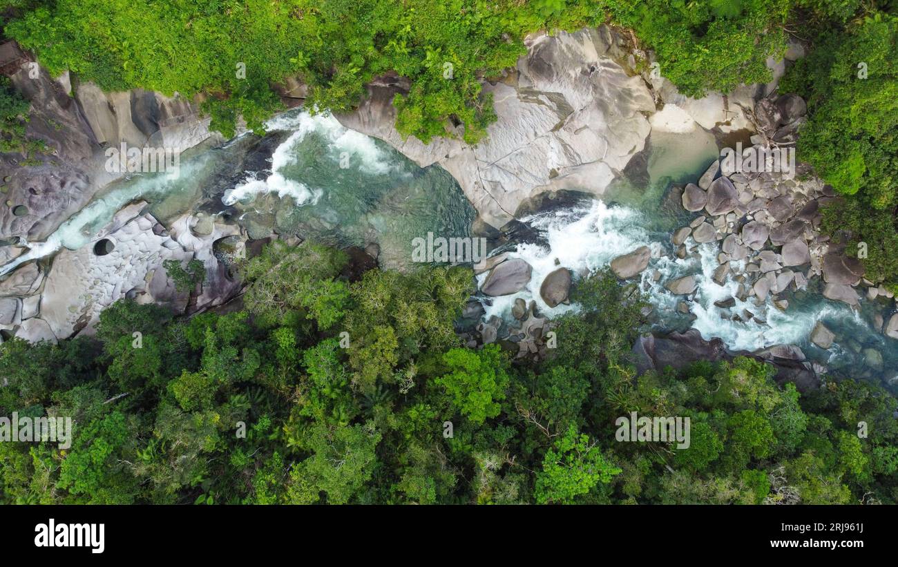 Aerial view of Babinda Boulders, a tropical rainforest waterfall in ...