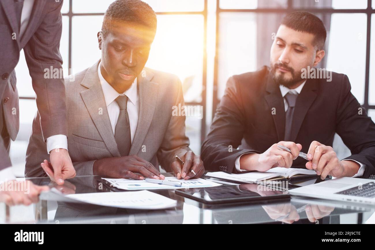 Three business people in the office working together Stock Photo - Alamy