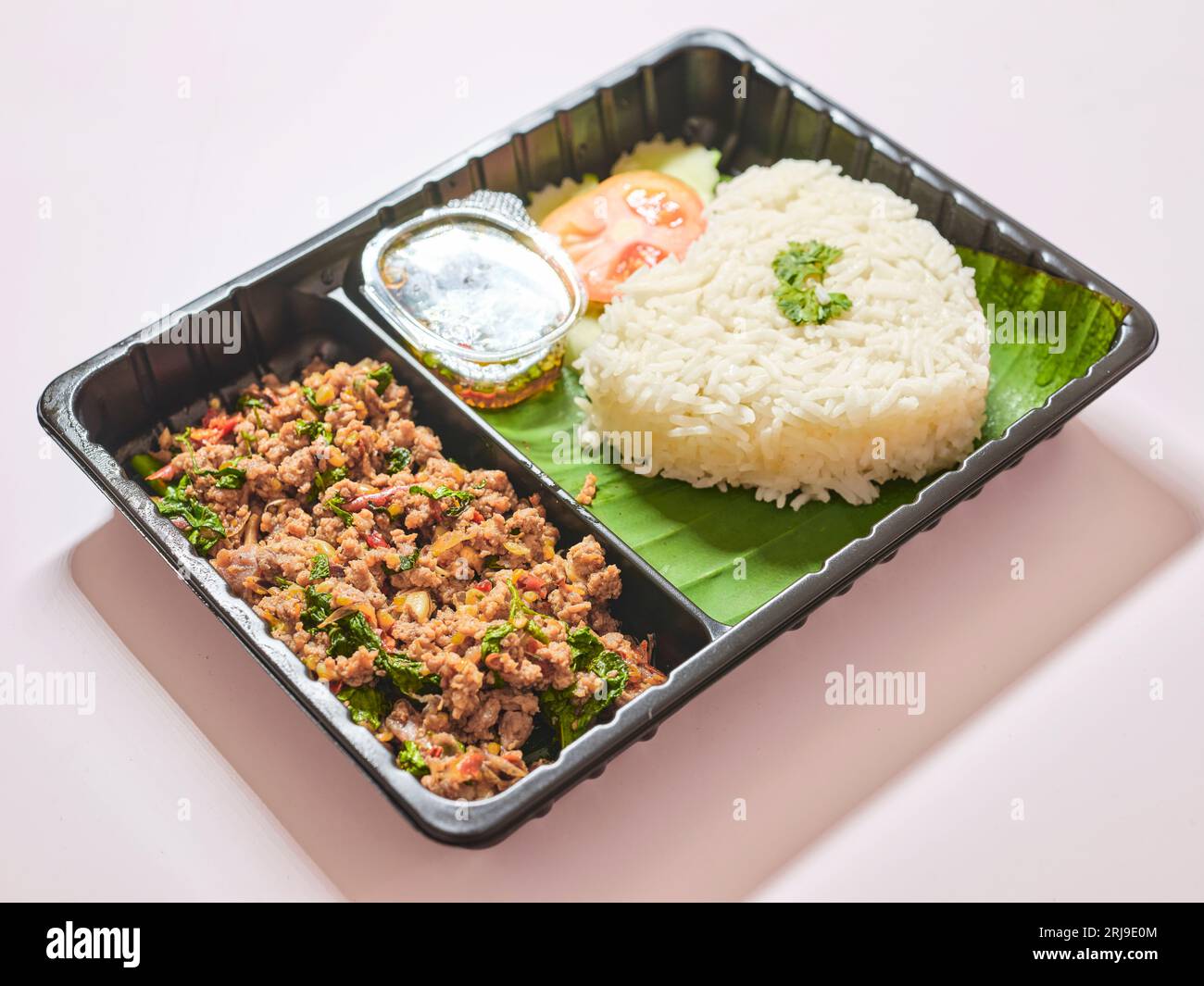 Basil fried rice with pork in plastic box at street market , fast food ...