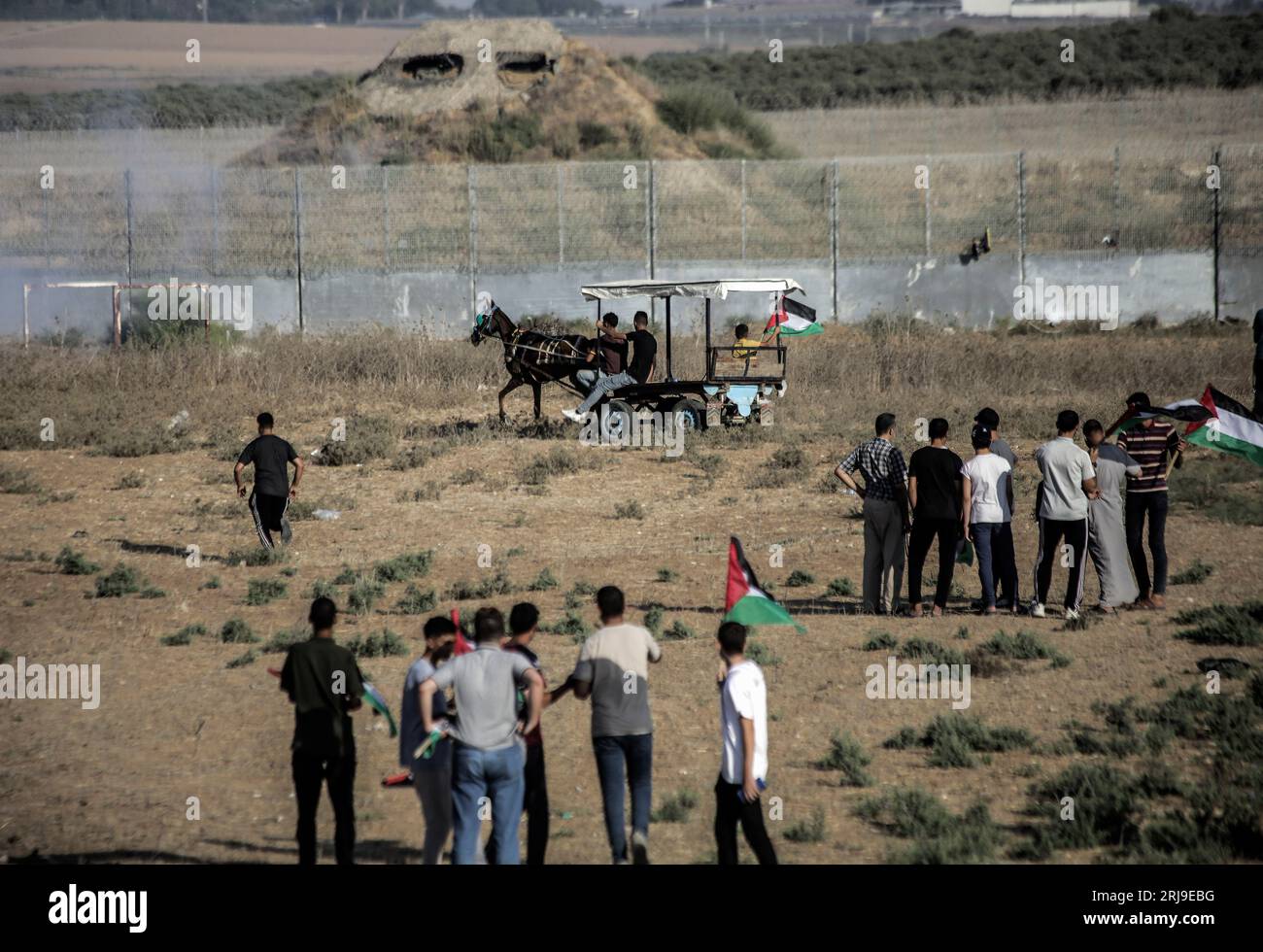 Gaza, Palestine. 21st Aug, 2023. Palestinians ride a horse-drawn cart ...