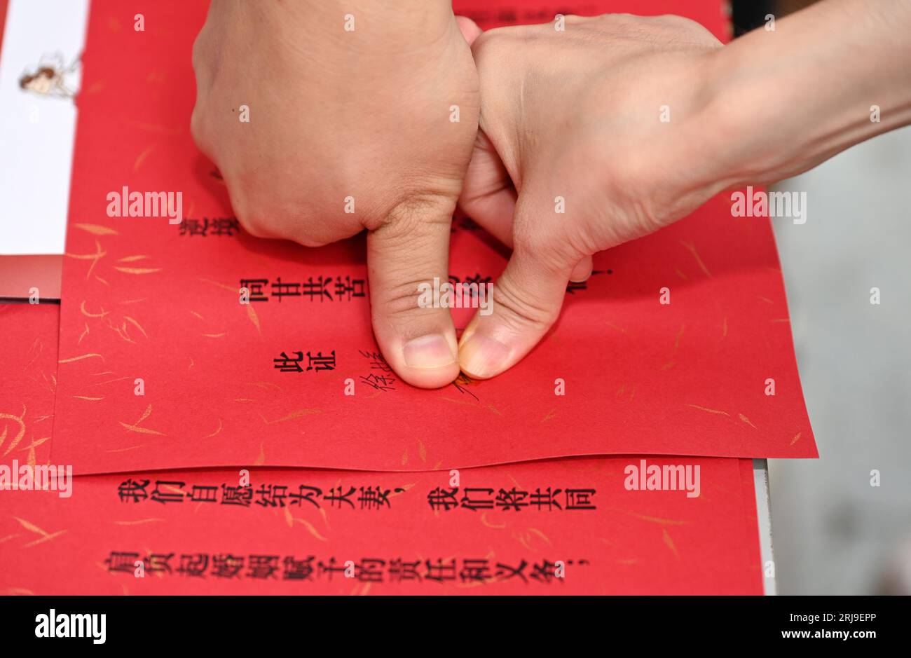 NEIJIANG, CHINA - AUGUST 22, 2023 - A couple presses their fingerprints ...
