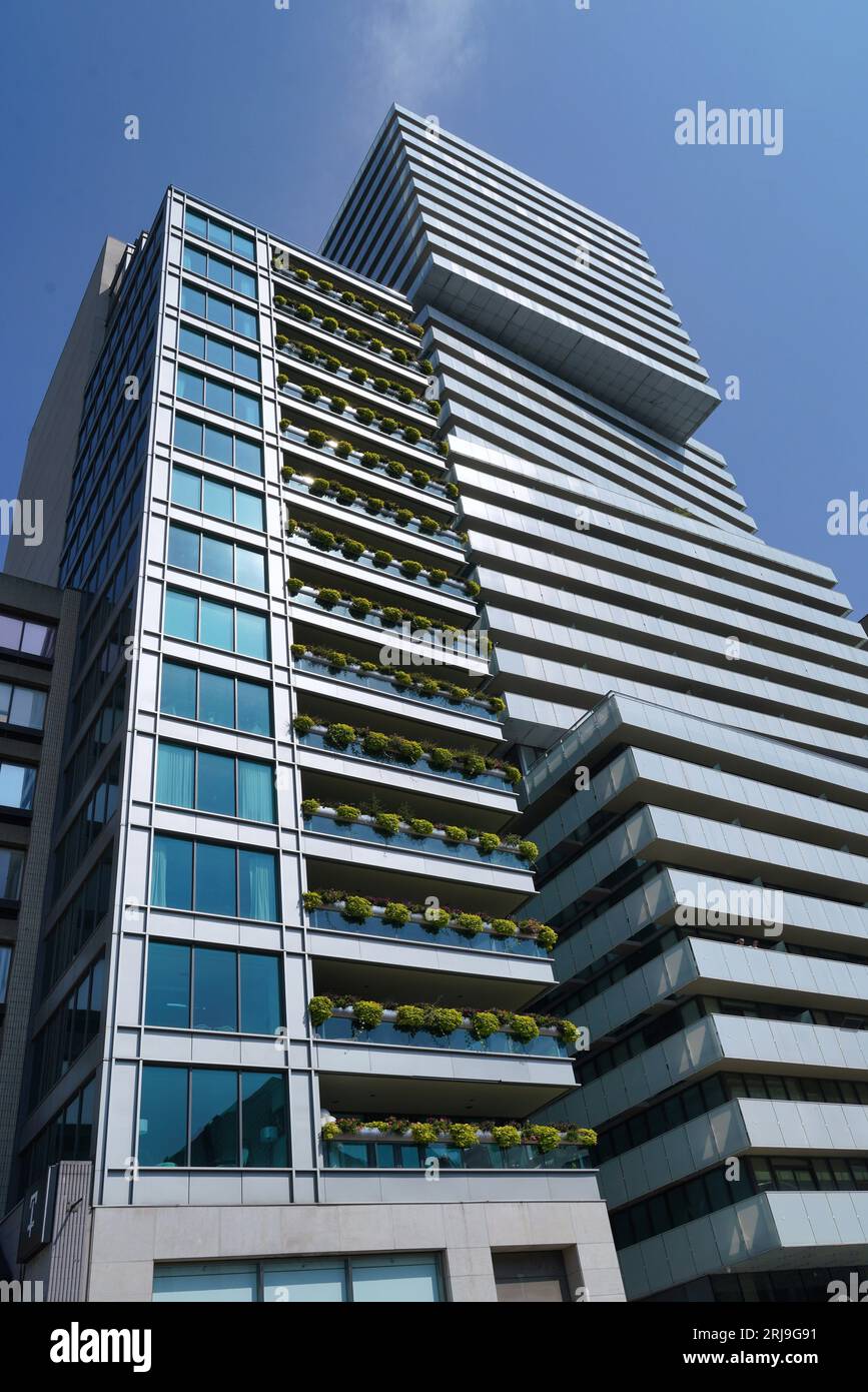 Modern highrise apartment building wtih plants on balcony Stock Photo ...