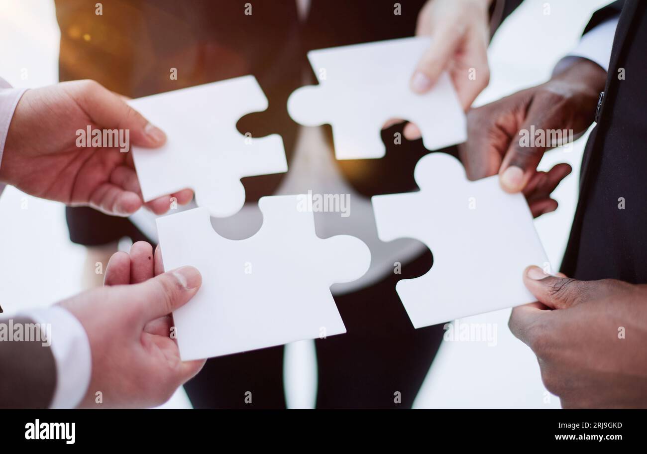 Group of business people assembling jigsaw puzzle and represent team ...