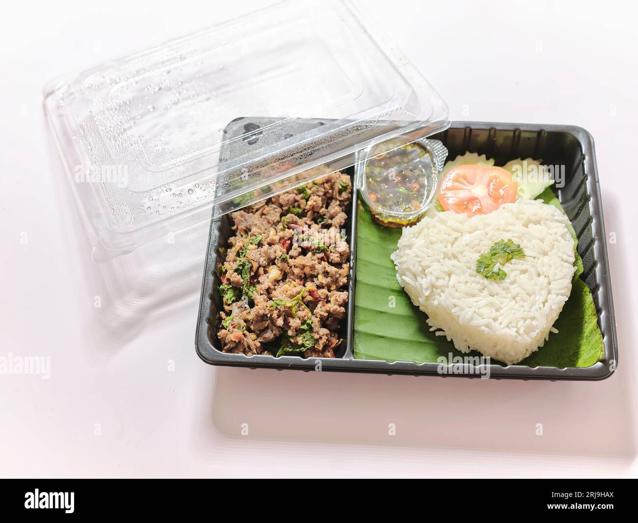 Basil fried rice with pork in plastic box at street market , fast food ...