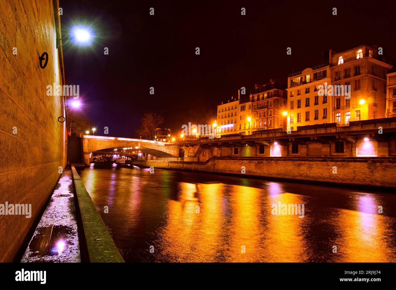 River Seine and Petit Pont bridge at night at Paris France Stock Photo ...