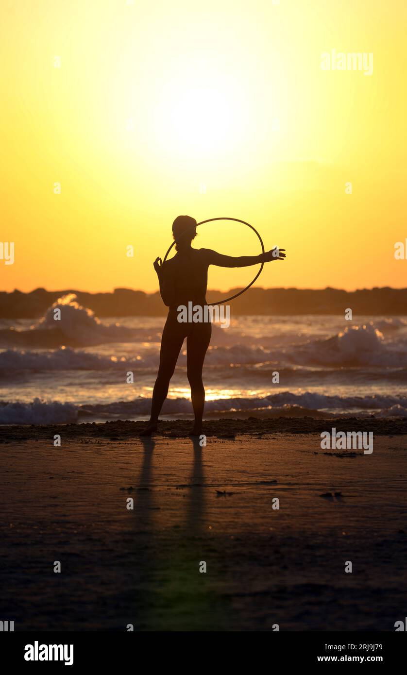 A woman with her hula hoop on the beach in Tel-Aviv, Israel Stock Photo ...