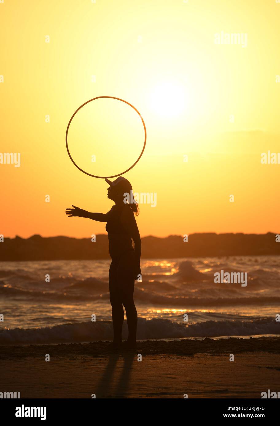 A woman with her hula hoop on the beach in Tel-Aviv, Israel Stock Photo ...
