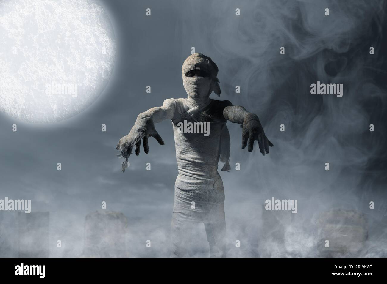 Mummy standing in the graveyard with a night scene background. Scary ...