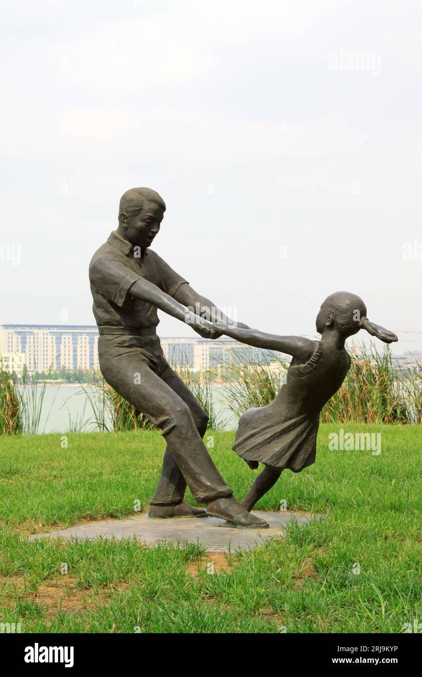 Dance sculpture in the park, green grass, beautiful environment Stock ...
