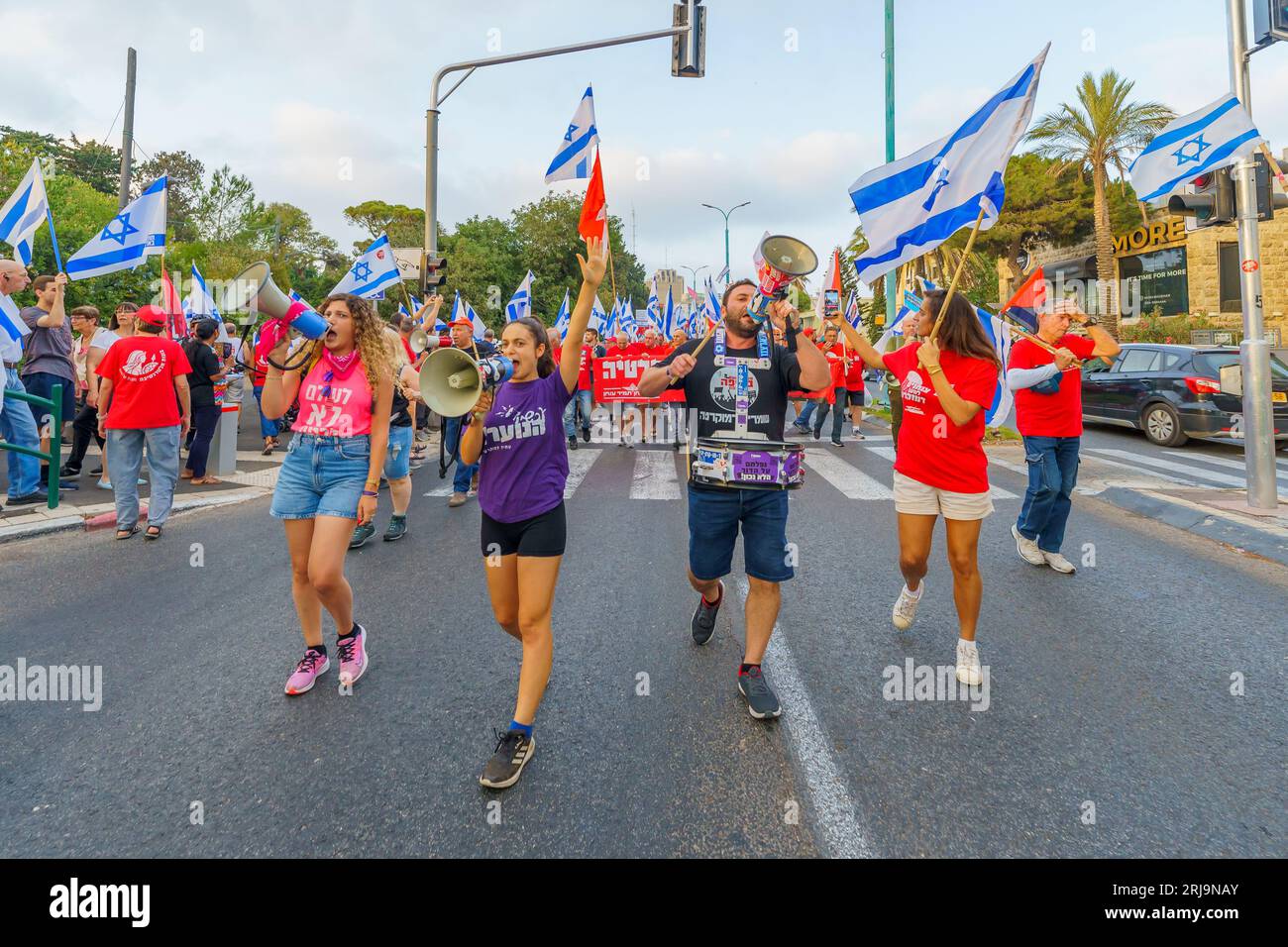 Haifa, Israel - August 19, 2023: People march with various flags and ...