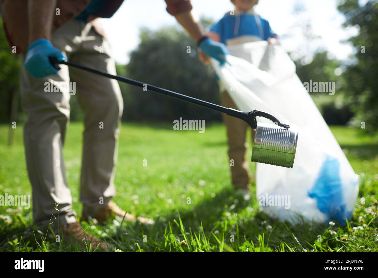 Child picking up litter in a forest hi-res stock photography and images ...