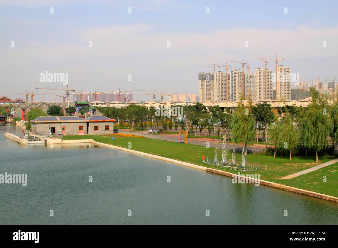Traditional architecture and unfinished high rise building in a scenic ...