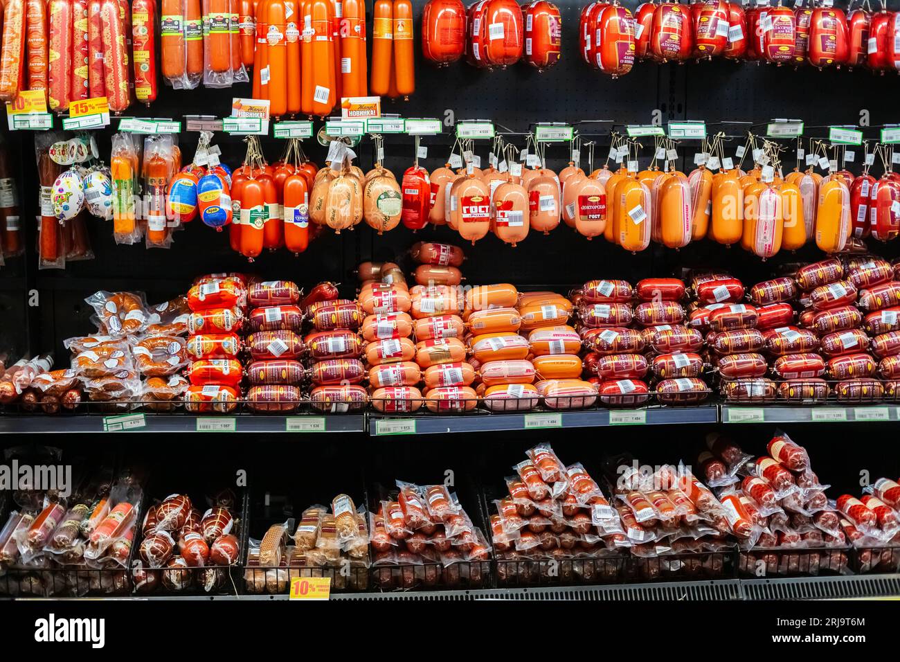 different types of sausages, salami on store shelves. grocery shop ...