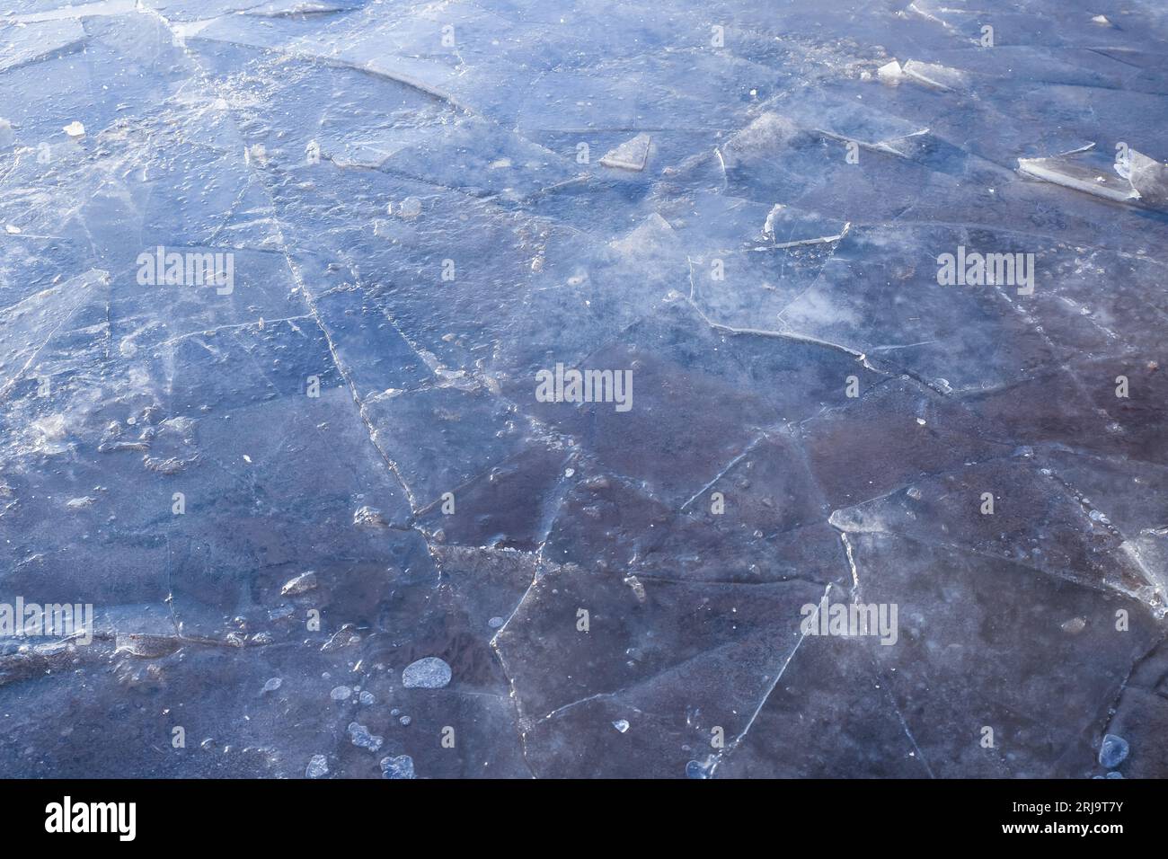 ice on water, lake, river, puddle. texture background with cracks on ...