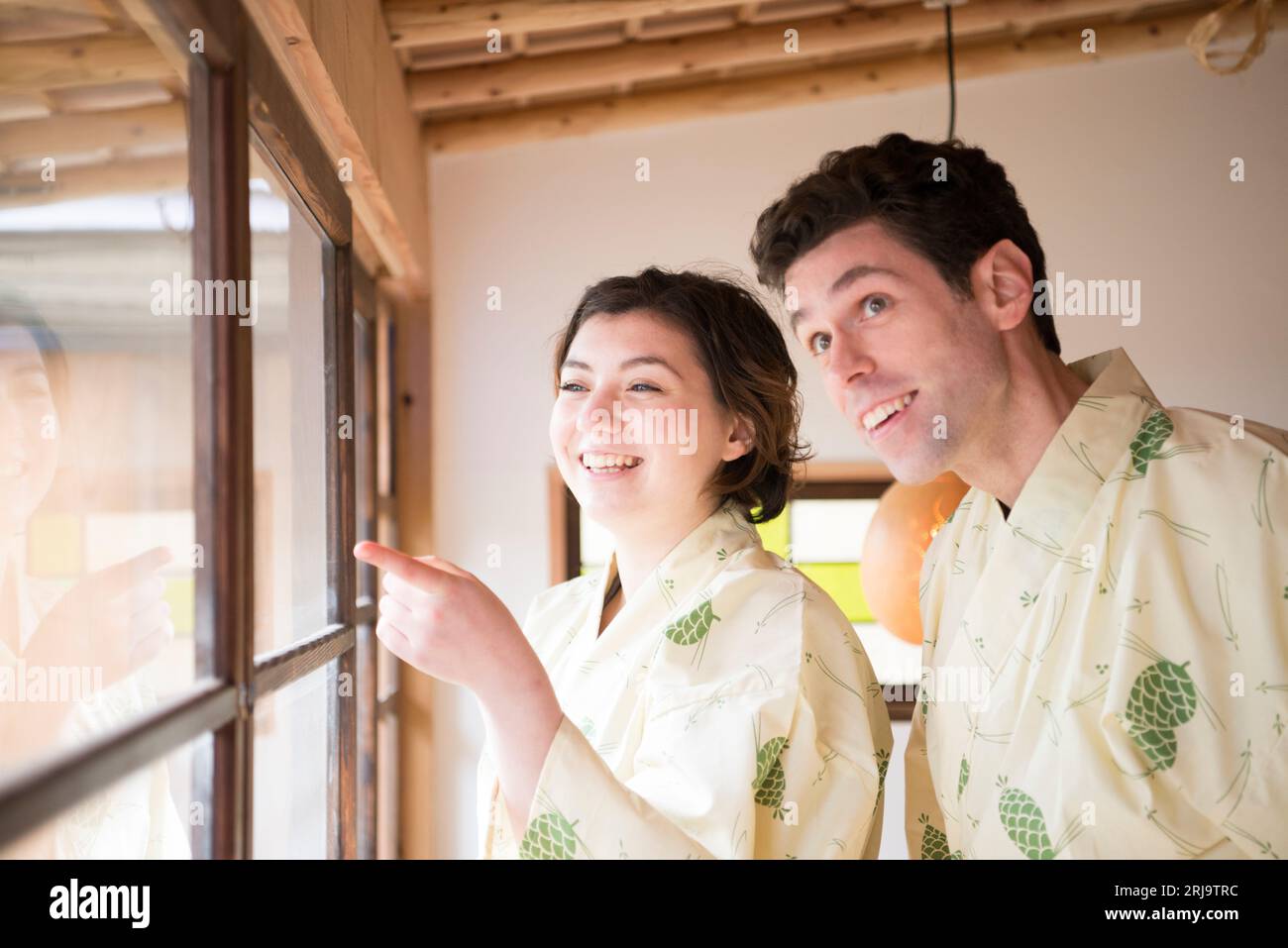 Foreign couple in yukata looking out the window Stock Photo - Alamy