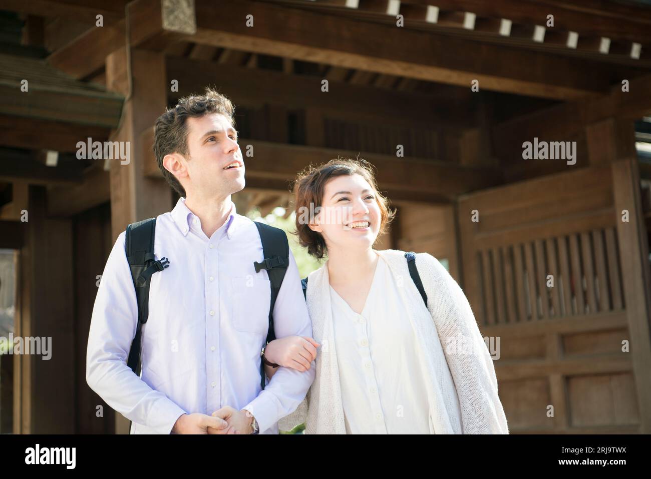 Foreign tourists laughing at a shrine Stock Photo - Alamy