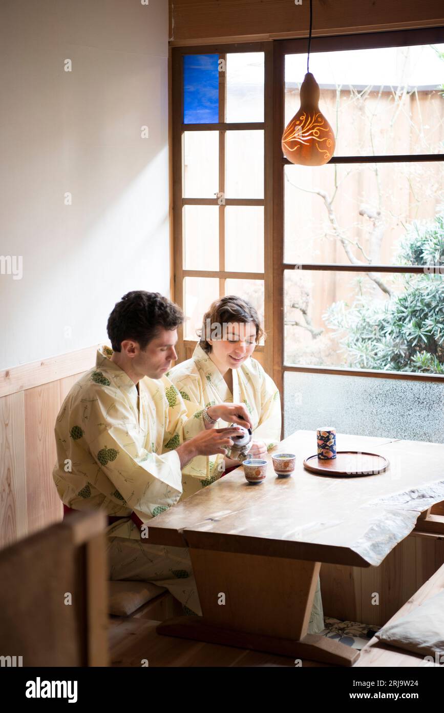 Foreign couple making tea in yukata Stock Photo - Alamy