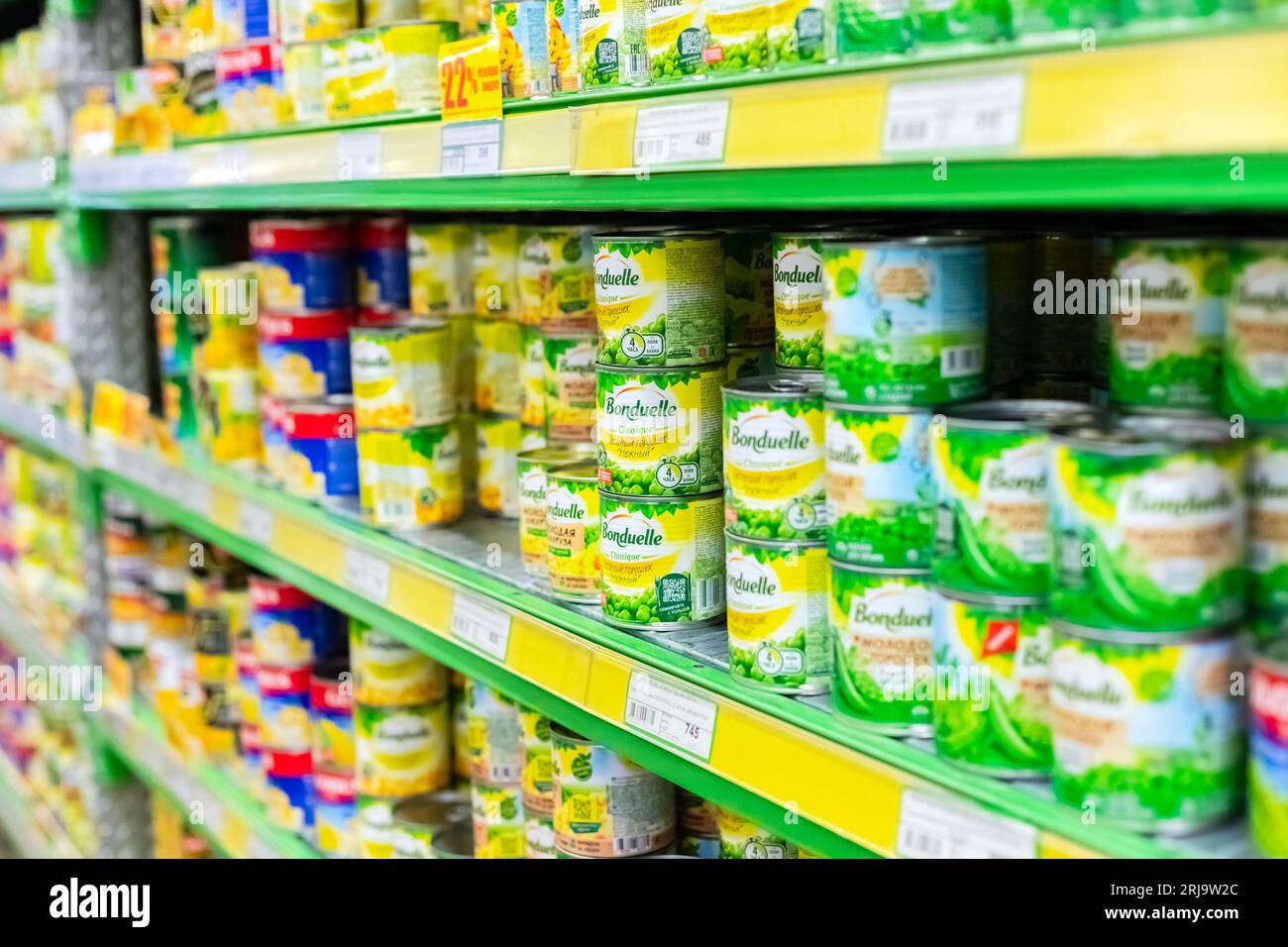 green peas in tin can Bonduelle on store shelves. grocery shop ...