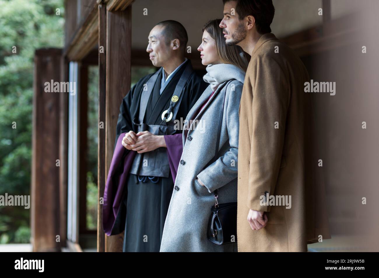 Foreign men and women with a priest giving a tour of the temple Stock ...