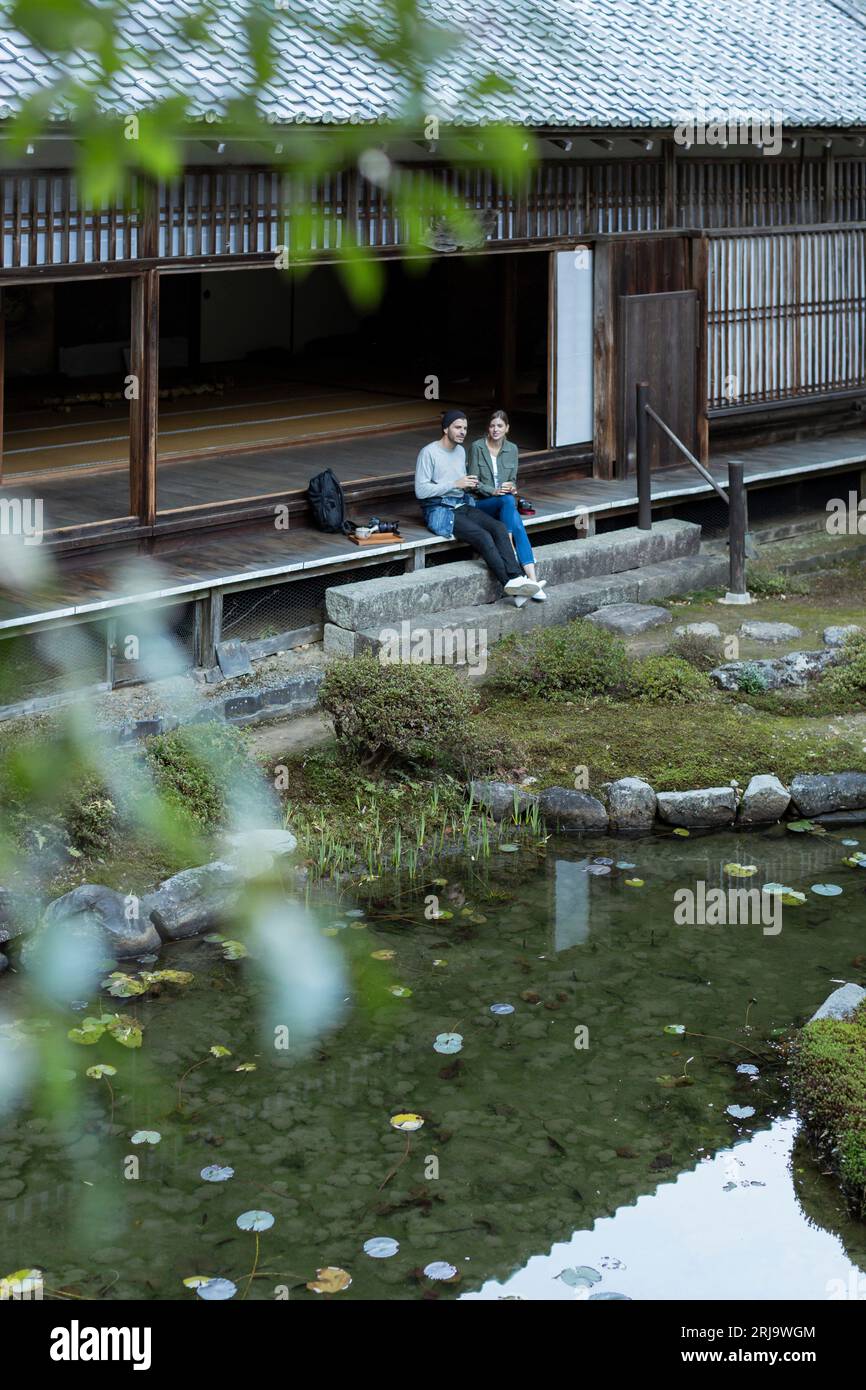 Foreign men and women sitting on the veranda Stock Photo - Alamy