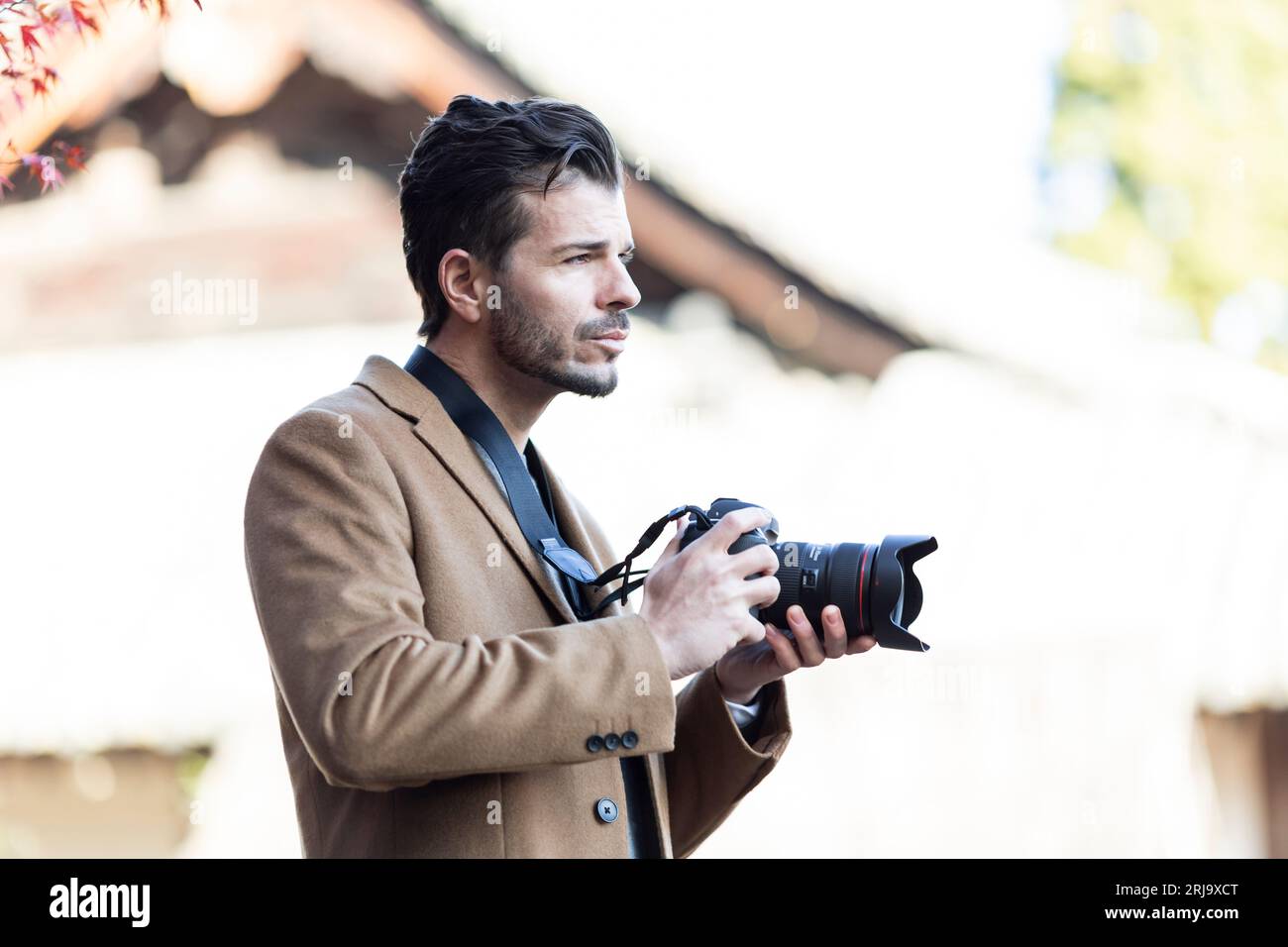 Foreign man taking a picture with a camera Stock Photo - Alamy