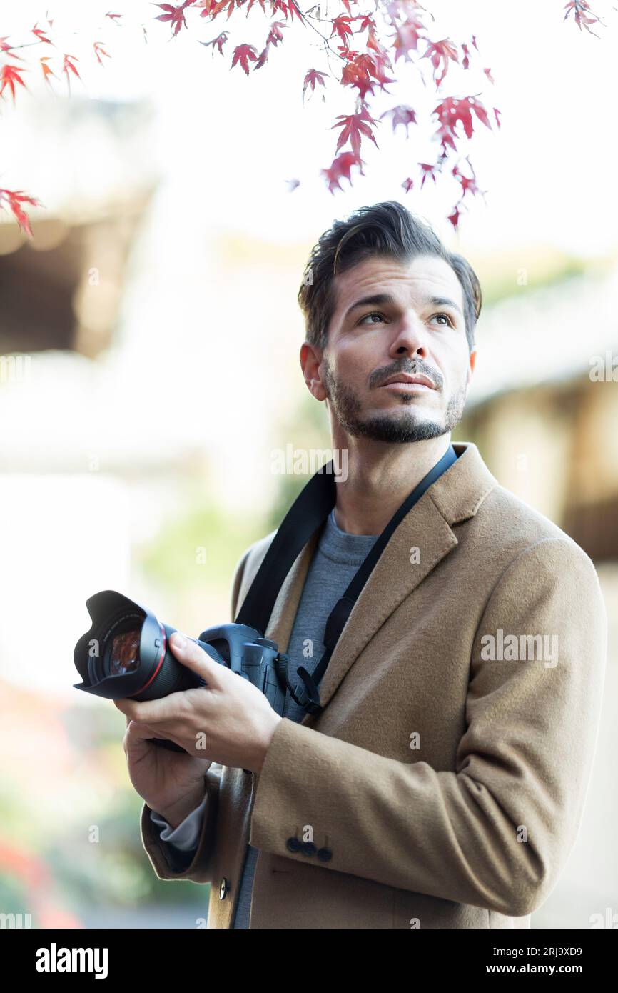 Foreign man taking a picture with a camera Stock Photo - Alamy