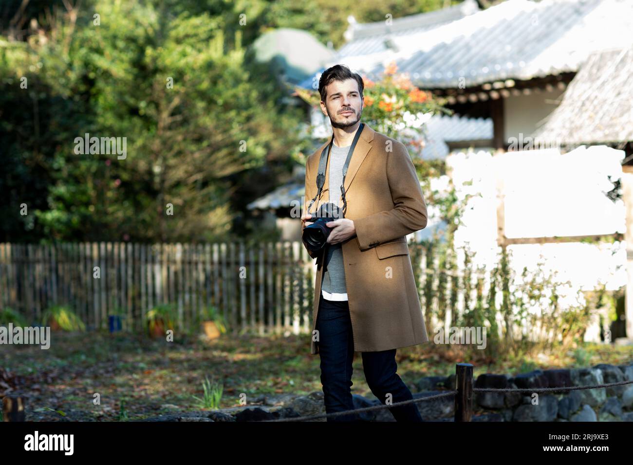 Foreign man taking a picture with a camera Stock Photo - Alamy