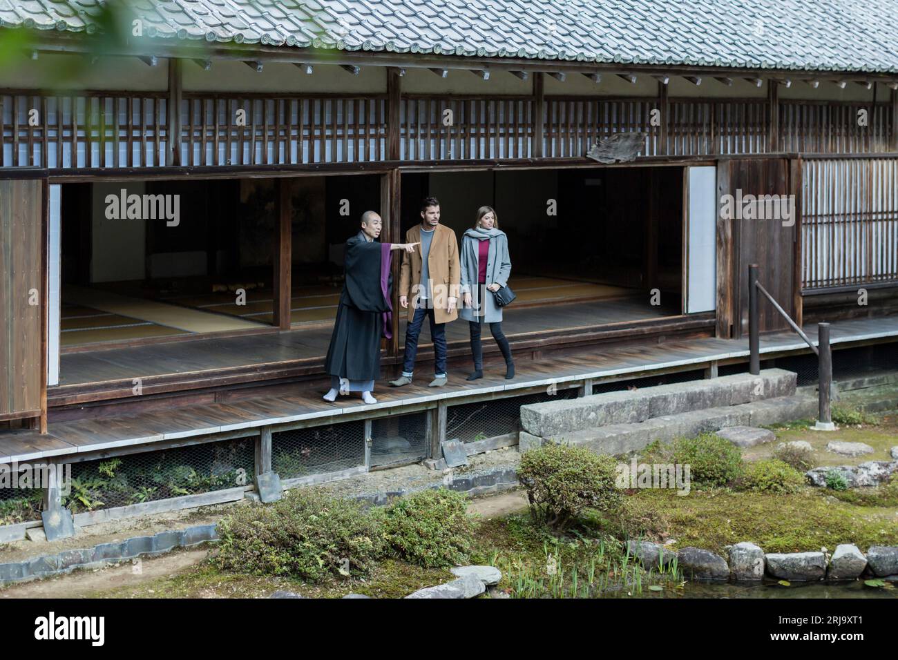 Foreign men and women touring a temple Stock Photo - Alamy