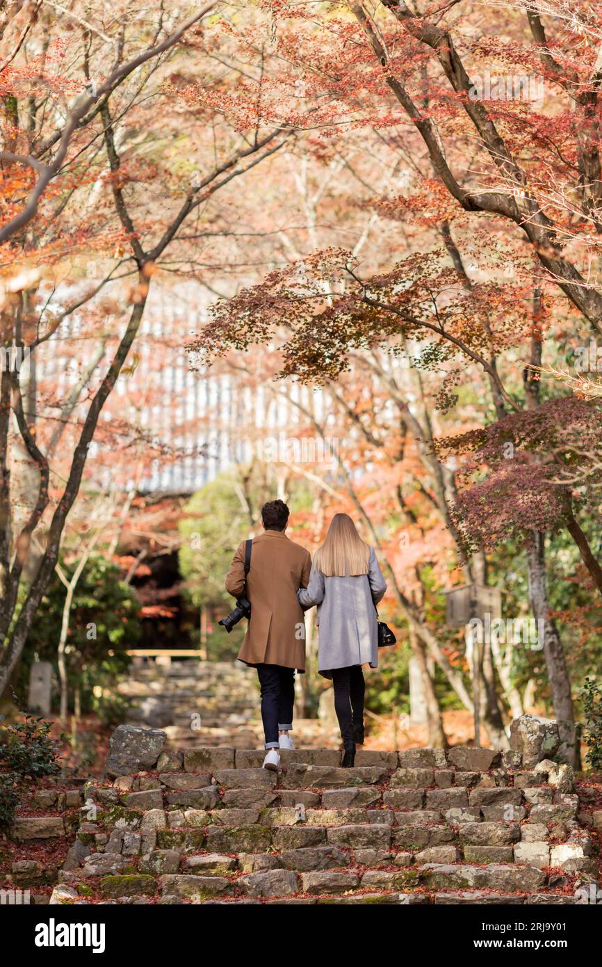 Foreign men and women walking along the approach to the temple Stock ...