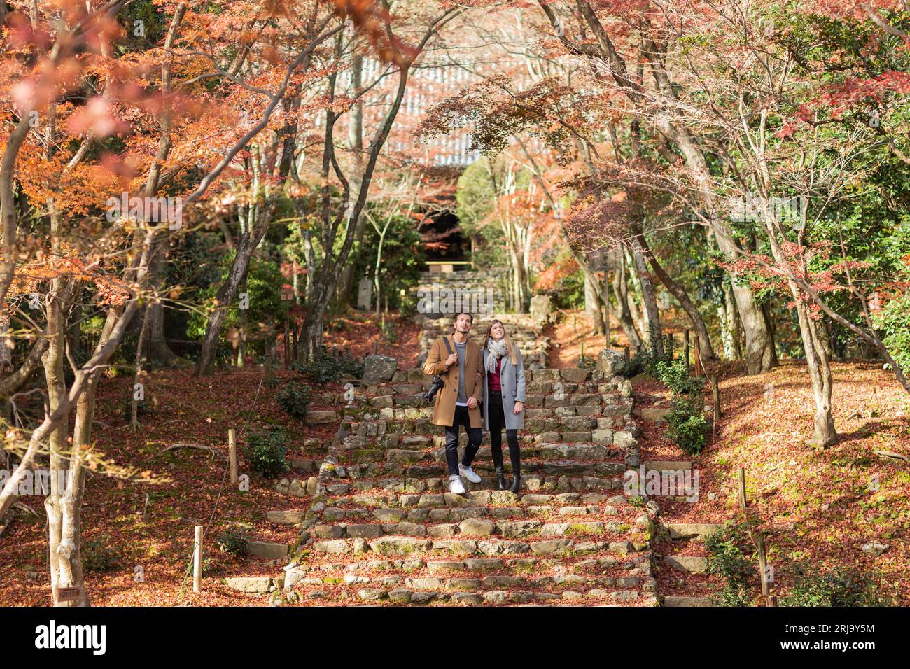 Foreign men and women walking along the approach to the temple Stock ...