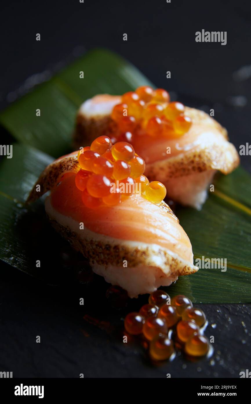 Seared salmon nigiri with salmon roe Stock Photo - Alamy