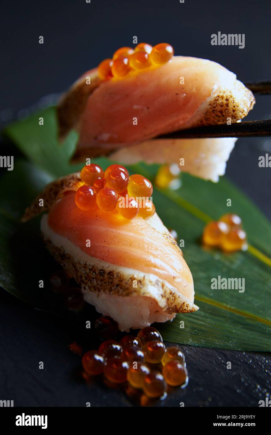 Seared salmon nigiri with salmon roe Stock Photo - Alamy