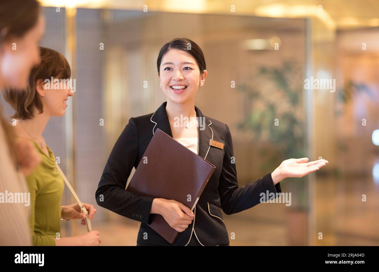 Concierge showing a foreigner around Stock Photo - Alamy