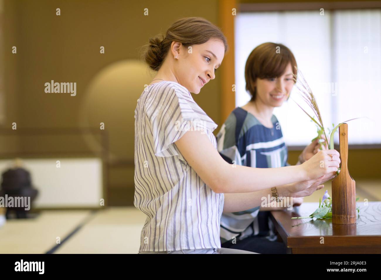 Foreign tourist arranging flowers Stock Photo - Alamy