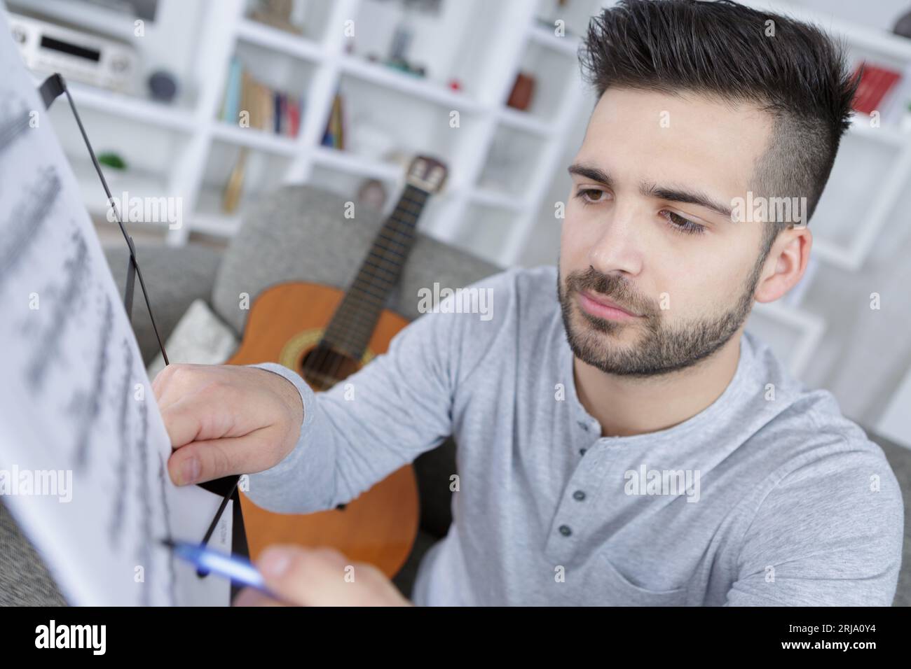 man practicing in playing acoustic guitar Stock Photo - Alamy