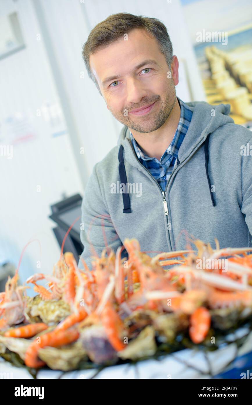 a fishmonger and a seafood platter Stock Photo - Alamy