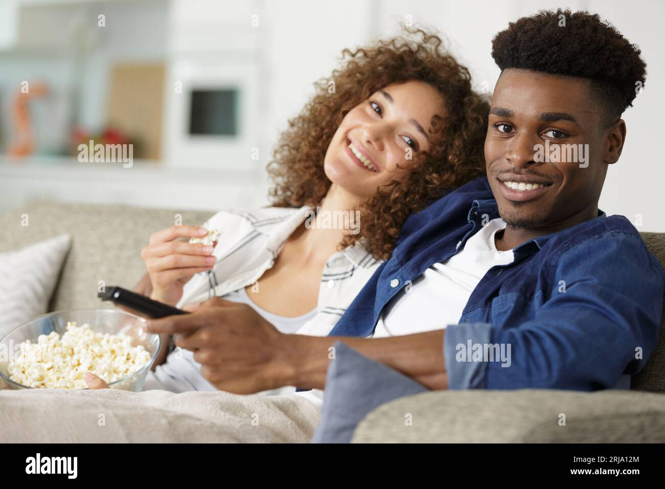 couple watching movies on the sofa Stock Photo - Alamy