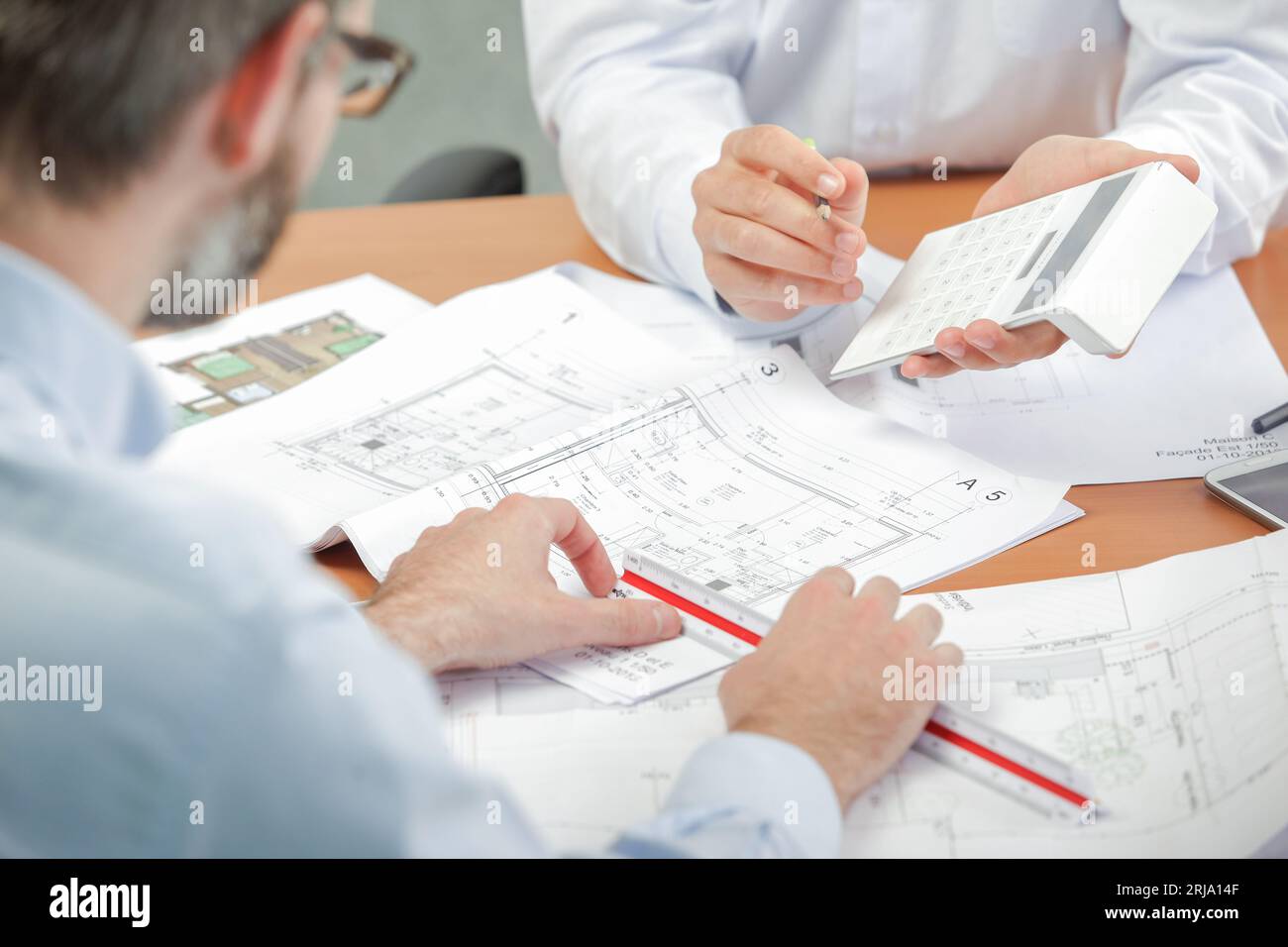 two men calculating in office Stock Photo - Alamy