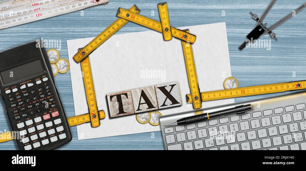 TAX text made of wooden blocks, folding ruler in the shape of a house ...