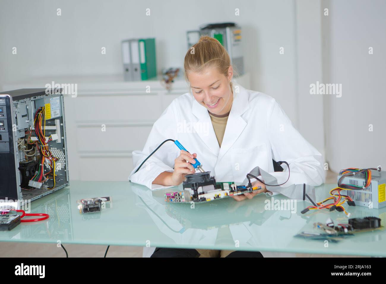 Woman engineer solders circuits sitting hi-res stock photography and ...