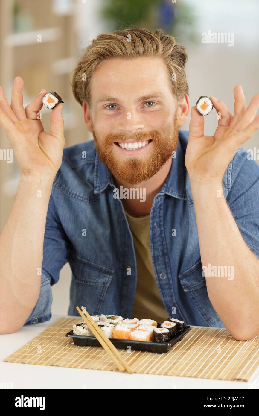 Man eating sushi rolls hi-res stock photography and images - Alamy