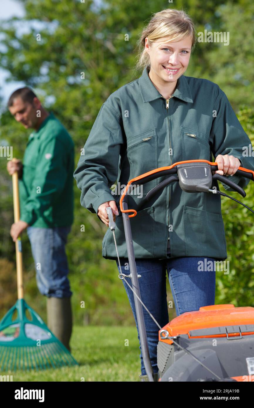 Woman pushing lawn mower hi-res stock photography and images - Alamy