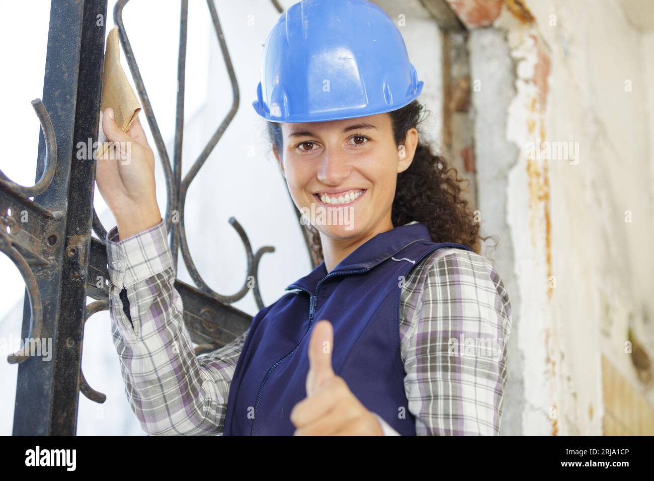 happy female builder showing thumb up Stock Photo - Alamy